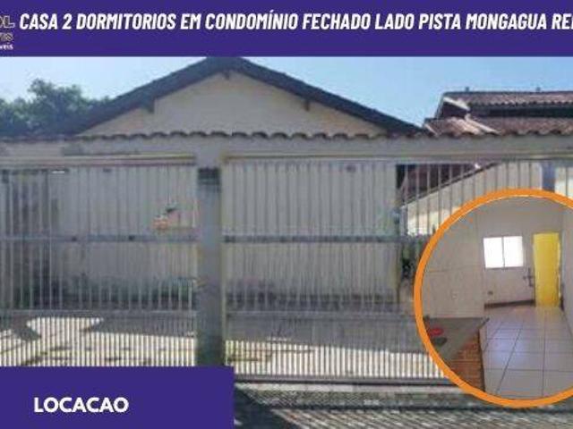 CASA 2 DORMITORIOS EM CONDOMÍNIO FECHADO LADO PISTA LOCAÇÃO MONGAGUA