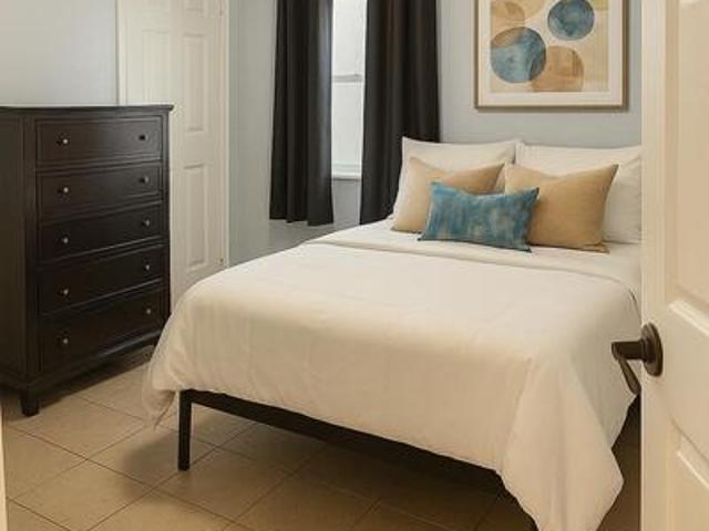 Common areas including living room and TV with large patio and back yard. Easy highway access