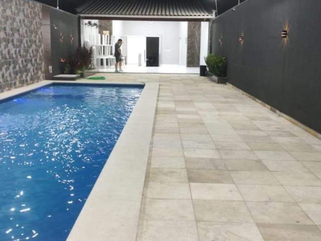 Espaço de festa com piscina e churrasqueira