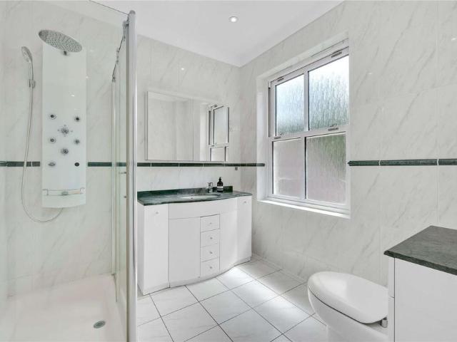 Fabulous light and spacious family home with wood flooring throughout, and set in one of the finest gated roads in Cobham