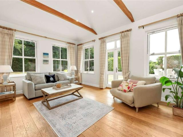 Fabulous light and spacious family home with wood flooring throughout, and set in one of the finest gated roads in Cobham
