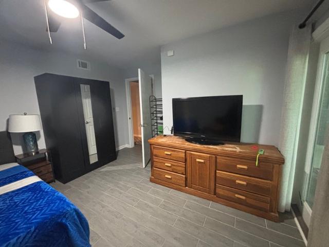 Furnished bedroom with shared kitchen and bathroom