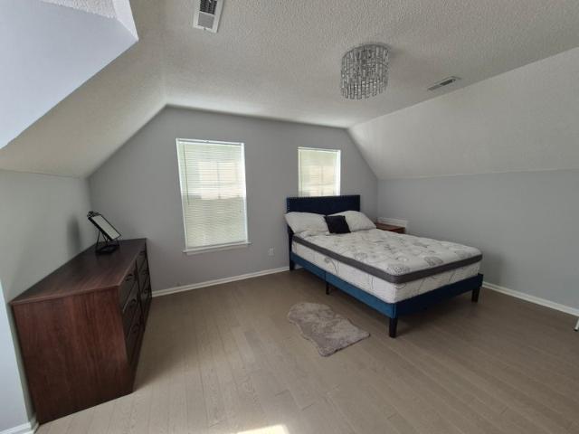 Furnished master bedroom with walk in closet