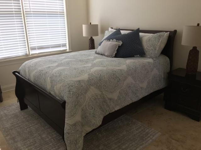 Furnished master bedroom with a personal bathroom