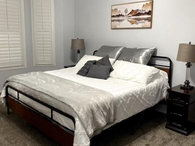 Furnished master bedroom with a personal bathroom