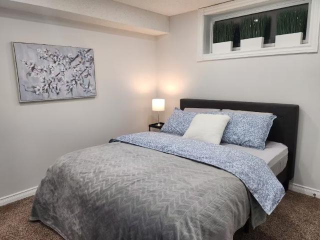 Furnished master bedroom with an attached bathroom