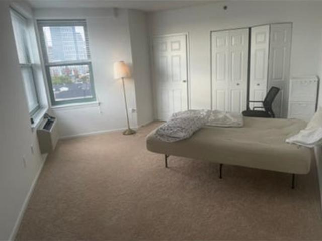 Furnished master bedroom with attached bathroom