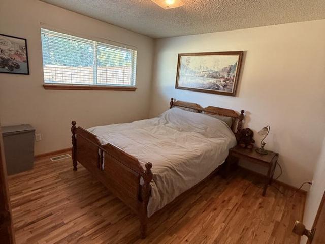 Furnished Room with queen bed and closet