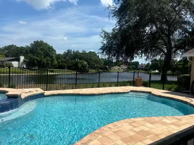 Large pool home on lake in golf course community! Turn key and.