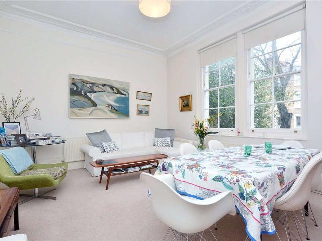 Large raised ground floor apartment on a tree lined street