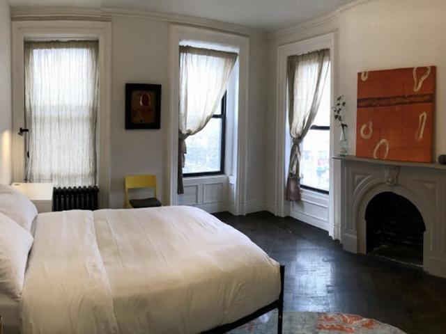 Large room with three windows on Myrtle Ave