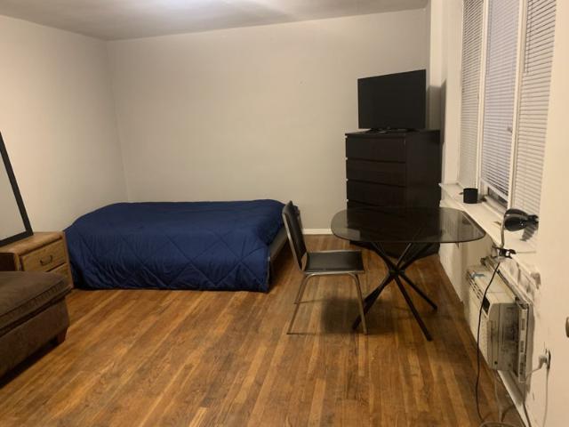 large sunny room close to subway next to a mall