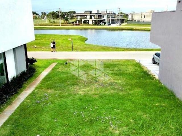 Lote frente lago no Condomínio Sunset em Xangri lá