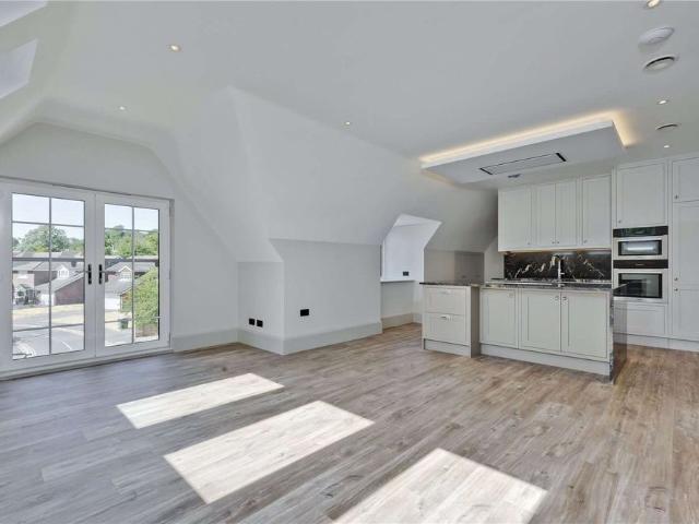 Luxurious lateral apartment set on one of Esher's premier roads in a gated development