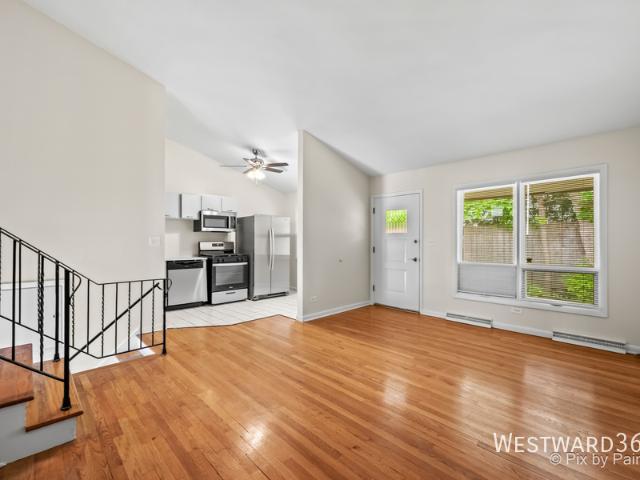 Newly updated 3 bedroom Townhome w/Stainless appliances, parking Across from Metra!