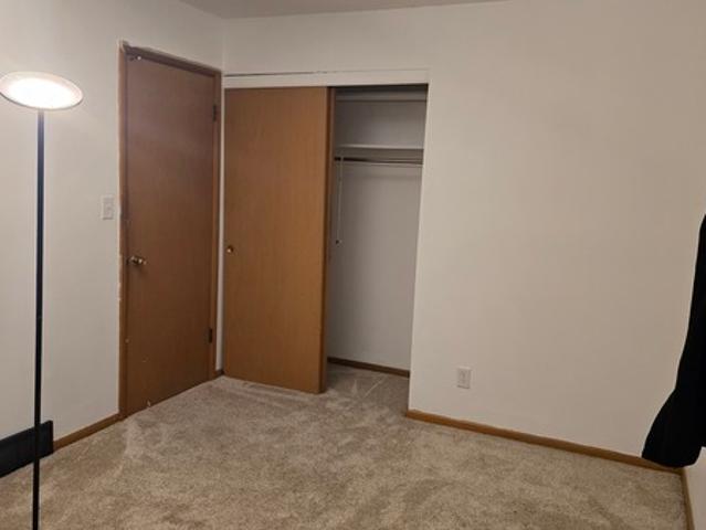 Private bedroom with built in shelves and closet