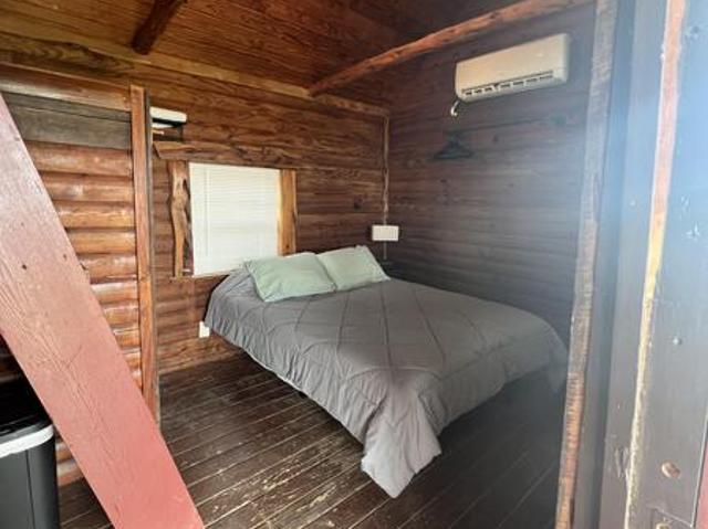 PRIVATE 2 person max Cedar Creek Log Cabin with covered porch 6 miles from I130