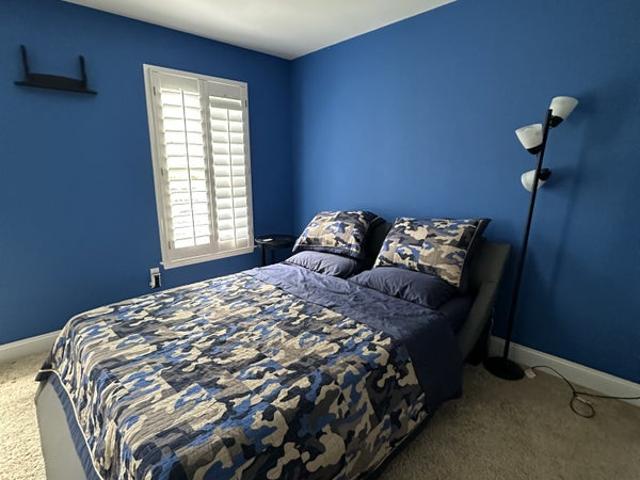 Room furnished with bedding and TV with private ba