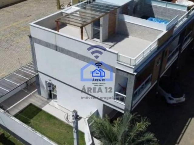 Sobrado triplex à venda no bairro do Massaguaçu em Caraguatatuba, SP Localizado a apenas 150m da p
